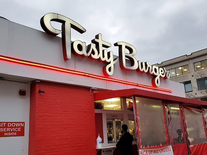 The neon glow of Tasty Burger's sign against the twilight sky beckons like a lighthouse for the hungry and flavor-deprived. Boston's answer to late-night cravings.