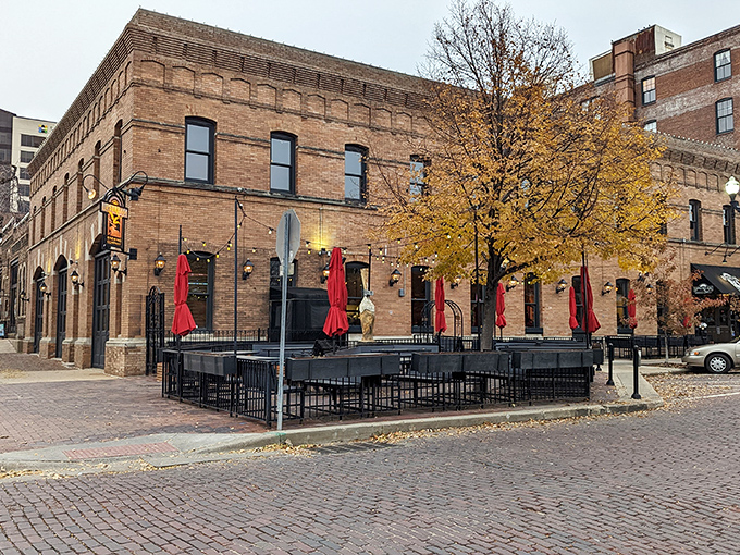 The historic brick façade of Upstream Brewing Company welcomes you to Omaha's Old Market district, where culinary magic awaits behind those wooden doors.