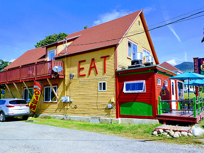 The yellow and red exterior of Nachos Mexican Bar and Grill stands out like a sombrero at a ski lodge, beckoning hungry travelers with its vibrant charm.