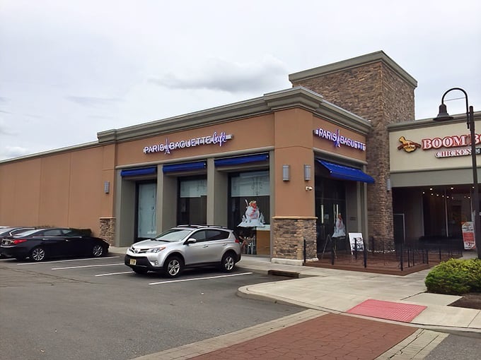 The Edison outpost of Paris Baguette beckons with its distinctive blue awnings and stone facade – like a modern French café that somehow landed in a New Jersey strip mall.
