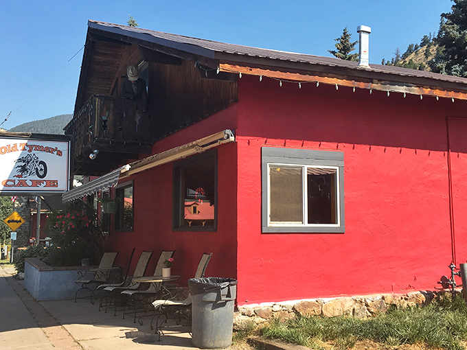 The unmistakable bright pink exterior of Old Tymers Cafe stands out against the mountain backdrop like a delicious landmark in Red River.