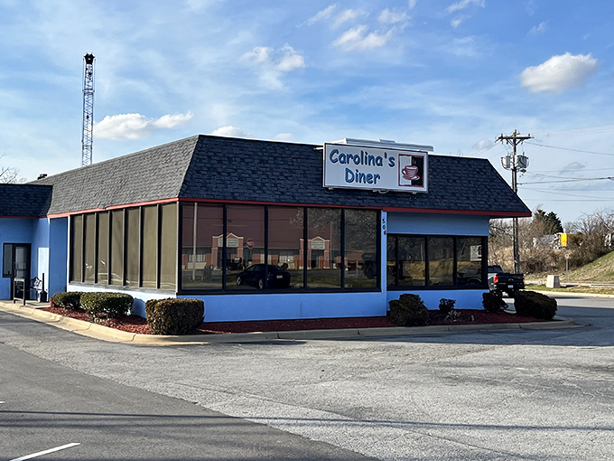 The blue-trimmed exterior of Carolina's Diner stands like a beacon of breakfast hope against the North Carolina sky. Comfort food paradise awaits!