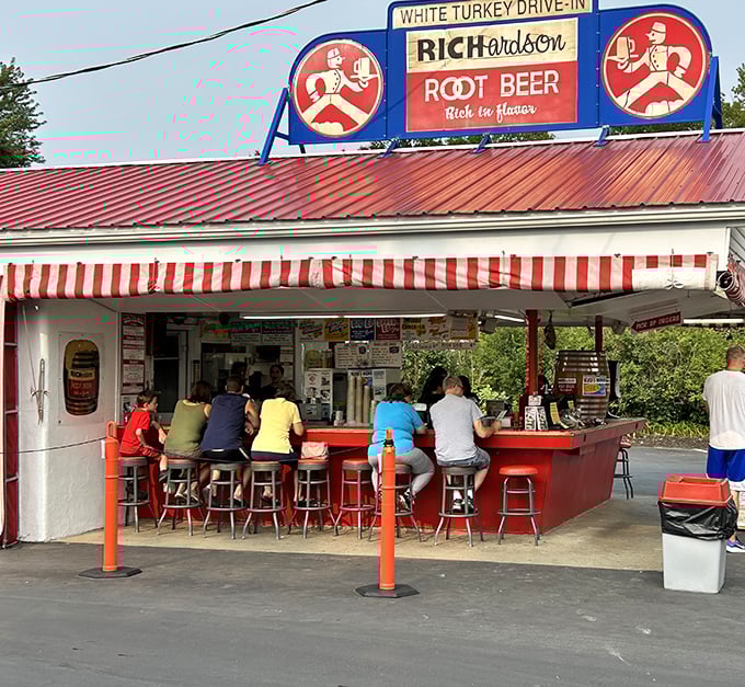 The iconic White Turkey Drive-In stands proudly with its red roof and striped awnings, a time capsule of Americana serving happiness on a tray since generations.