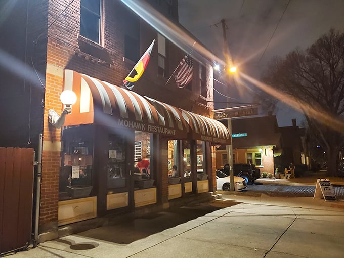 That iconic striped awning isn't just a canopy—it's a beacon for hungry souls wandering German Village after dark. Comfort food salvation awaits.
