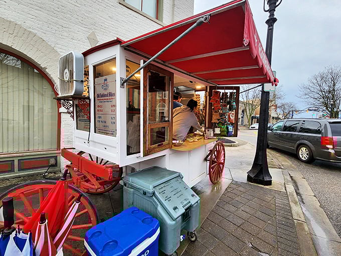 The iconic Hamburger Wagon stands proudly on Miamisburg's Main Street, its red awning and wagon wheels a beacon for burger enthusiasts since 1913.