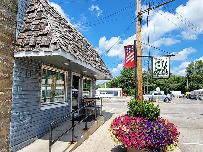 The weathered wooden shingle roof and patriotic bunting tell you everything – this isn't just a restaurant, it's a slice of Americana waiting to be savored.