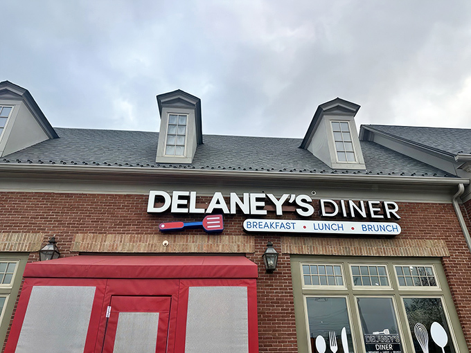 The brick facade and bright red doors of Delaney's Diner stand like a beacon of breakfast hope on East Main Street in Columbus.