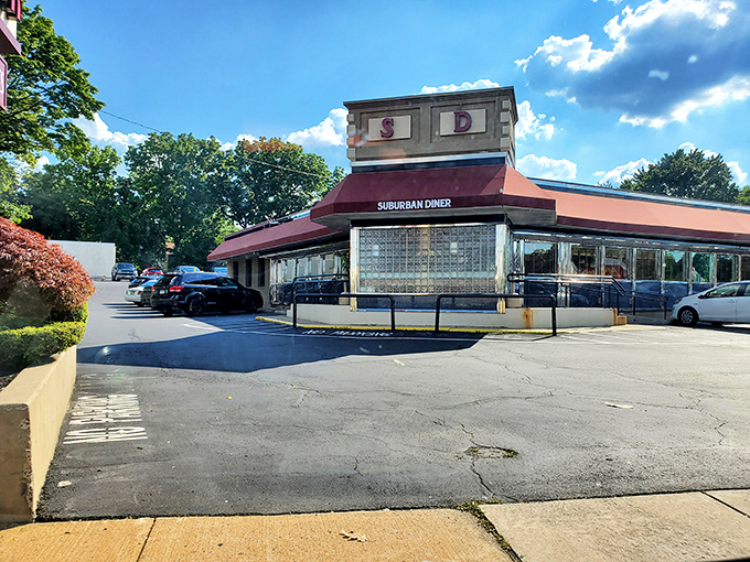 The iconic Suburban Diner sign promises "BAKING ON PREMIS" – a charming typo that somehow makes the anticipation of fresh-baked goods even more endearing. 