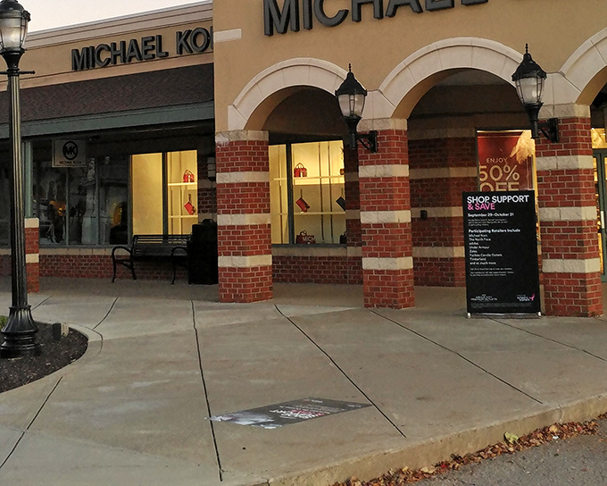 The Michael Kors store stands like a temple to handbag devotees, its brick and cream facade promising treasures within that won't require a second mortgage.