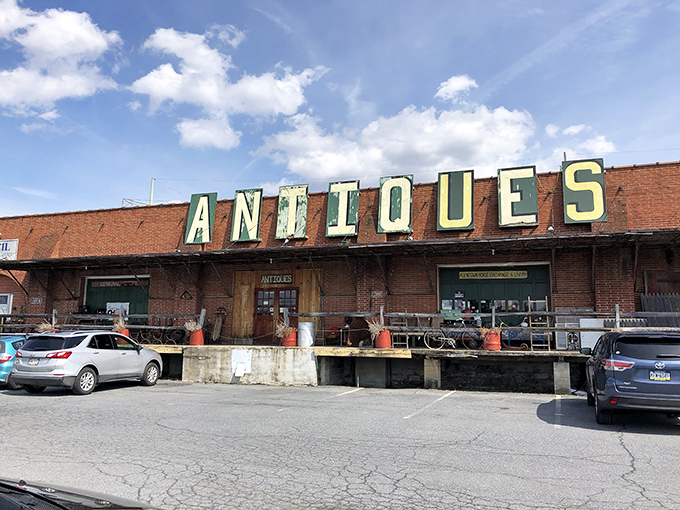 The weathered brick exterior with its vintage "ANTIQUES" sign promises treasures within—like a time capsule disguised as a building in Allentown.