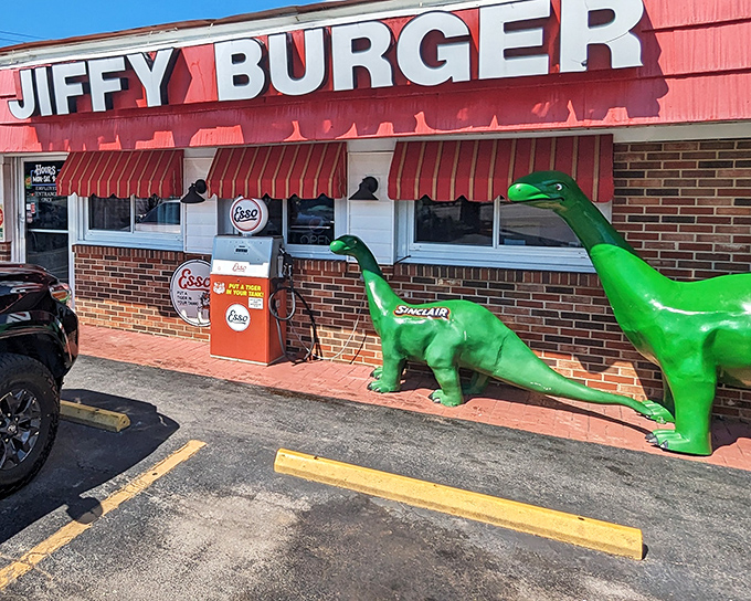 The green Sinclair dinosaur stands guard outside Jiffy Burger like a prehistoric bouncer who's really into comfort food. Red awnings and vintage gas pumps complete this time-travel tableau.