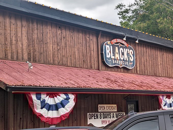 The wooden facade with its weathered red roof and patriotic bunting isn't just announcing "Texas"—it's practically singing the state anthem while waving a Lone Star flag.