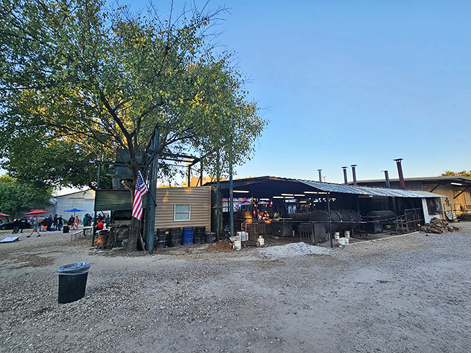 The pilgrimage begins here – rustic smokers, weathered wood, and that iconic water tower standing like a barbecue lighthouse guiding hungry souls home.