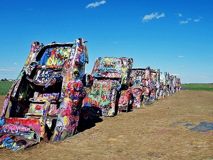 Ten Cadillacs nose-diving into the Texas dirt like synchronized swimmers who forgot the "swimming" part. American automotive history meets desert art installation.