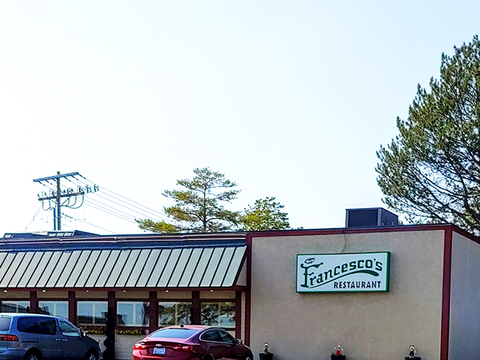Francesco's modest exterior hides culinary treasures within, like finding a Lamborghini parked behind a garden shed. The blue awning signals Italian delights await.