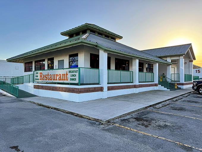 The green-roofed sanctuary of breakfast dreams stands proudly against the Florida sky, promising honest food without the fuss.