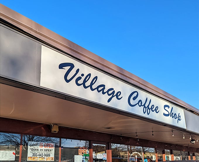 The iconic Village Coffee Shop sign stands proudly against the Colorado blue sky, promising breakfast salvation to hungry Boulder residents.