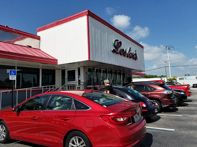 The iconic red and white exterior of Lester's Diner stands like a time capsule of Americana, beckoning hungry travelers with promises of comfort food paradise.