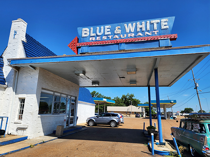 The iconic Blue & White Restaurant stands as a time capsule of Americana, its vintage gas station canopy beckoning hungry travelers along Highway 61.