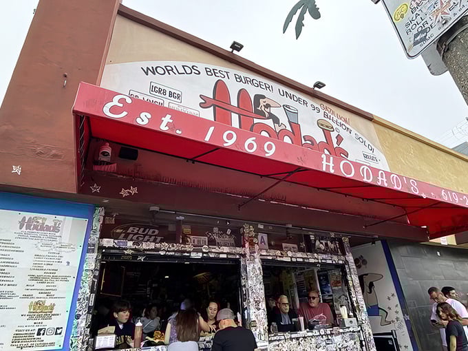 The iconic red awning of Hodad's boldly claims "World's Best Burger!" – a statement that seems less like bragging and more like a public service announcement once you've tasted their food.