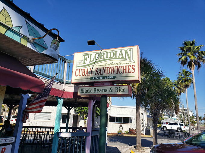 The Florida sunshine seems to shine a little brighter on this mint-green and burgundy sandwich haven, where "CUBANS" isn't just signage—it's a promise.
