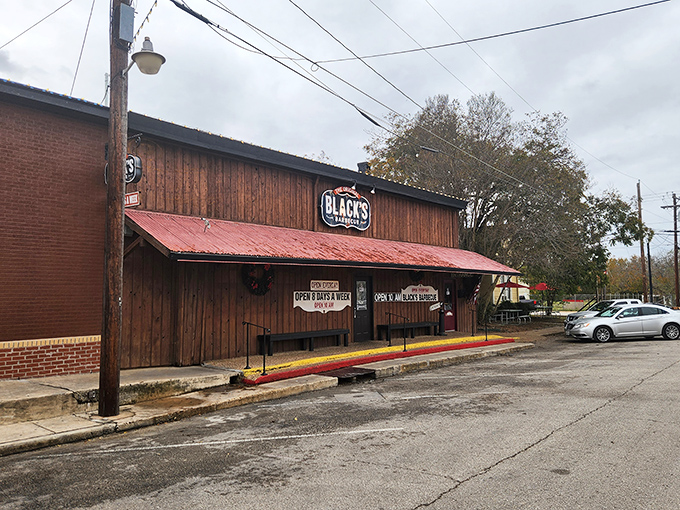 The wooden facade with its weathered red roof and patriotic bunting isn't just announcing "Texas"—it's practically singing the state anthem while waving a Lone Star flag.