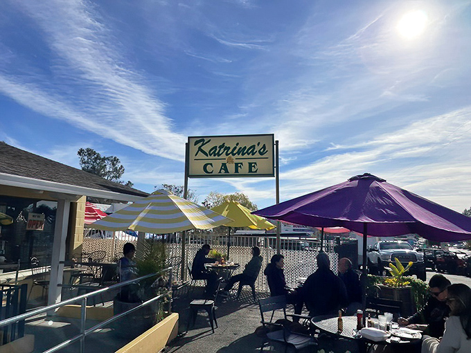 The sunny yellow exterior of Katrina's Café welcomes you like an old friend, complete with colorful umbrellas that practically whisper, "Come sit awhile."