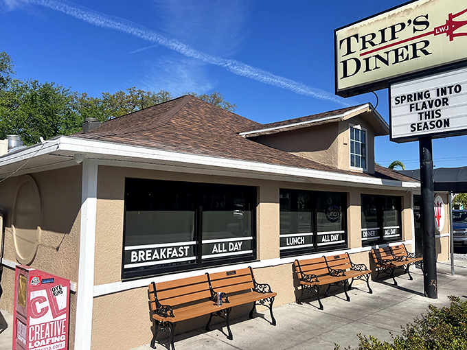 The welcoming exterior of Trip's Diner beckons hungry Tampa locals with its no-nonsense sign and cozy bench seating for the inevitable weekend wait.