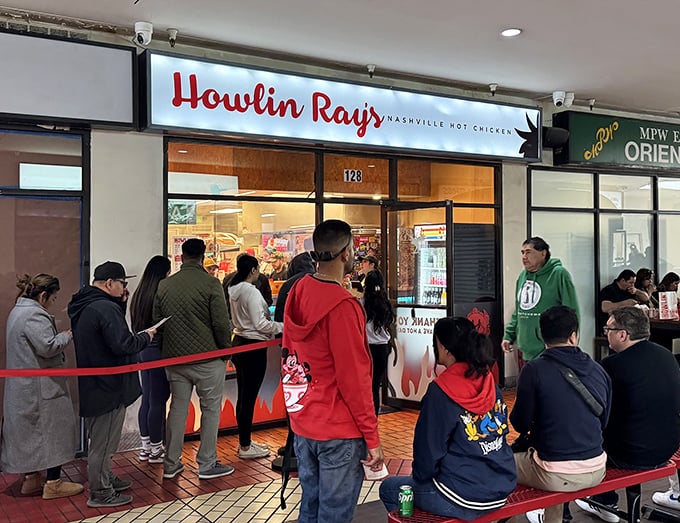 The fiery entrance to Howlin' Ray's beckons brave souls with its flame-adorned doors. This isn't just dinner—it's a delicious dare.