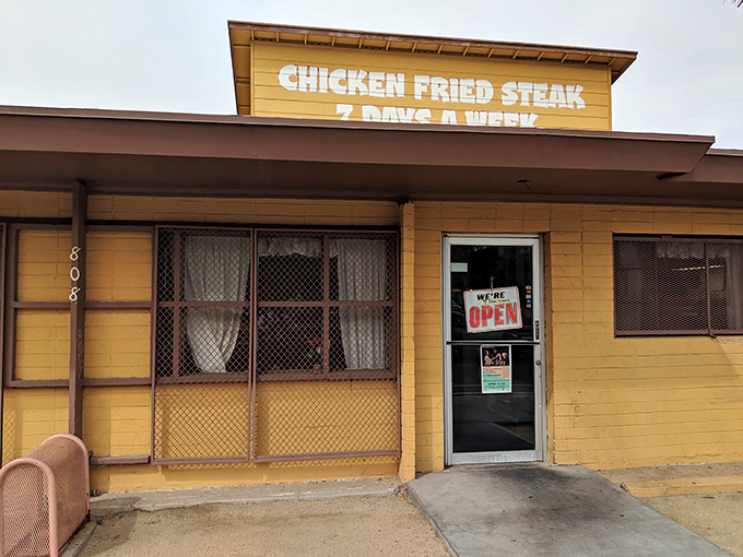 That cheerful yellow exterior and vibrant mural practically shout "comfort food paradise" from across the street.
