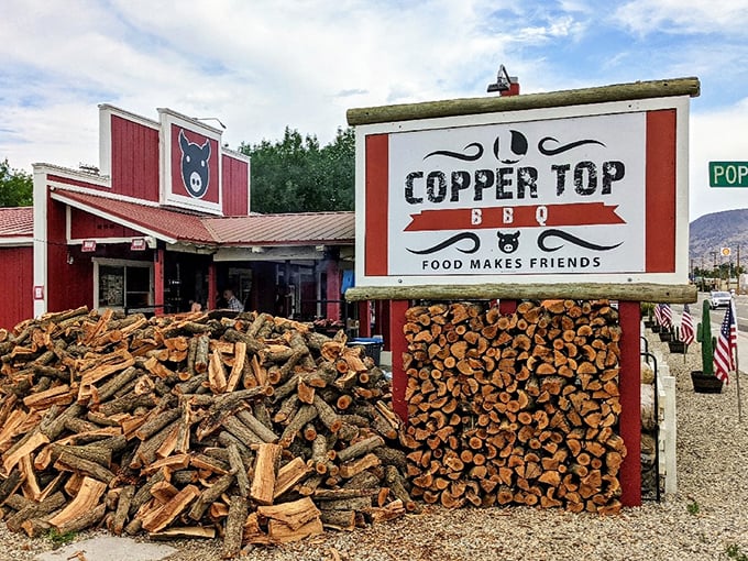 The iconic red barn-like exterior of Copper Top BBQ, where those massive smokers out front aren't just for show—they're the source of that heavenly aroma that hits you from a quarter-mile away.