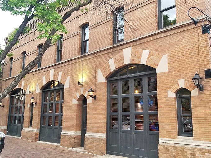 The historic brick façade of Upstream Brewing Company welcomes you to Omaha's Old Market district, where culinary magic awaits behind those wooden doors.