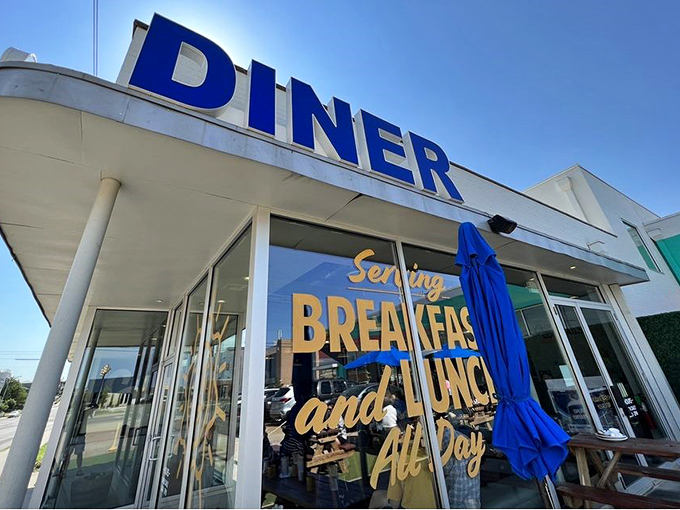 The iconic blue "DINER" sign beckons like a lighthouse for the breakfast-starved, promising all-day comfort in the heart of OKC.