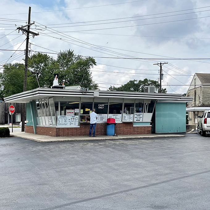 That top-hat-wearing chicken statue isn't just a mascot—it's a beacon of hope for hungry travelers on the Illinois highways.