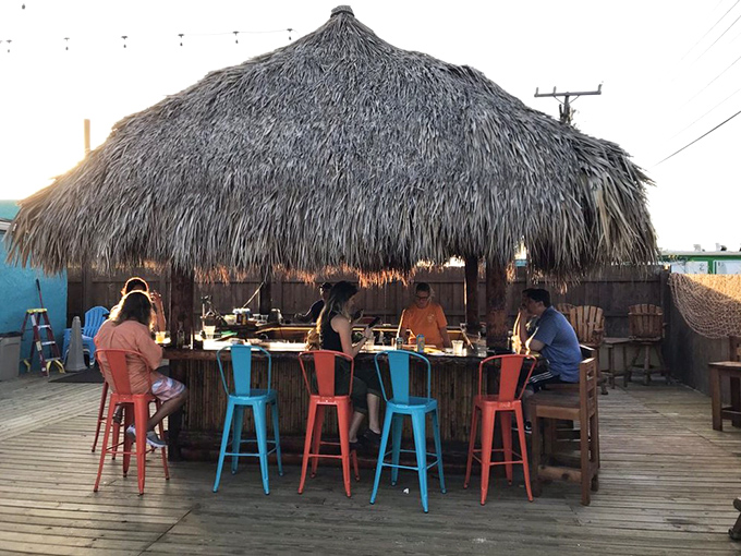 The quintessential tiki experience awaits under this meticulously crafted palm-thatched roof. Paradise isn't a place—it's this bar stool with an ocean breeze.