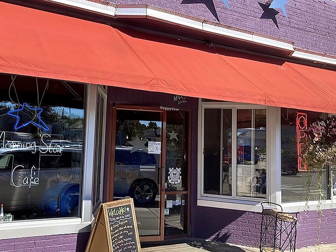 The purple facade with its cheerful red awning and hanging flower baskets isn't just eye-catching—it's nature's way of saying "breakfast is served!"