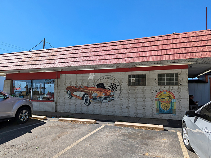 The exterior says it all – classic Corvette mural, jukebox art, and that distinctive red roof. Time travel begins at the parking lot.
