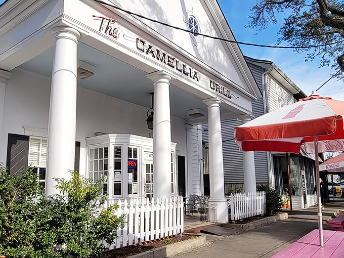 A Greek revival facade that houses burgers instead of philosophy—The Camellia Grill's columned entrance promises Southern hospitality with a side of architectural charm.