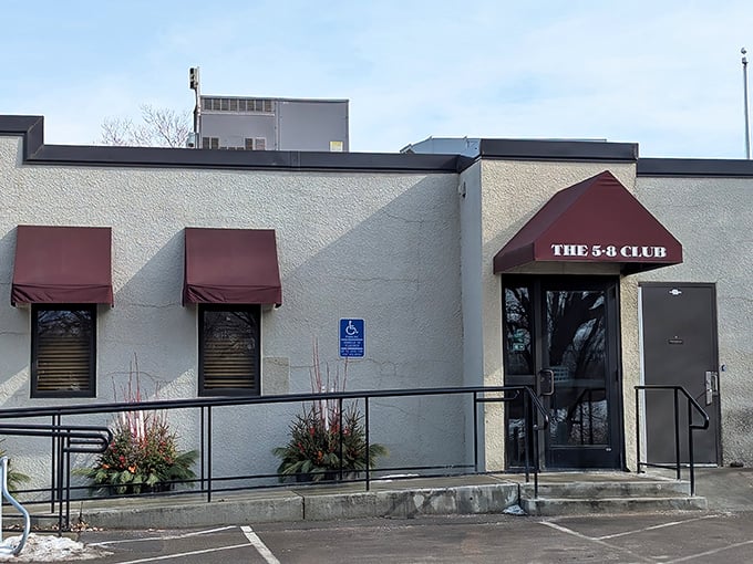 The unassuming exterior of 5-8 Club hides culinary greatness behind those burgundy awnings, proving that in Minnesota, legendary burgers don't need fancy facades.