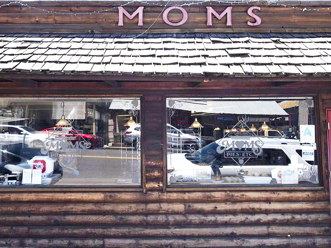 The rustic log cabin exterior of Mom's Pie House beckons like a siren song to pie lovers. Those red doors might as well be portals to dessert heaven.