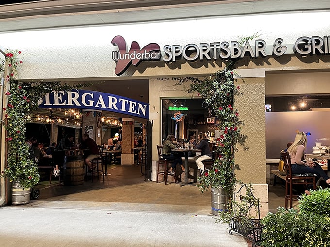 The green-roofed oasis of Wunderbar beckons with its vibrant red signage and lush entrance – a little slice of Bavaria hiding in plain sight.