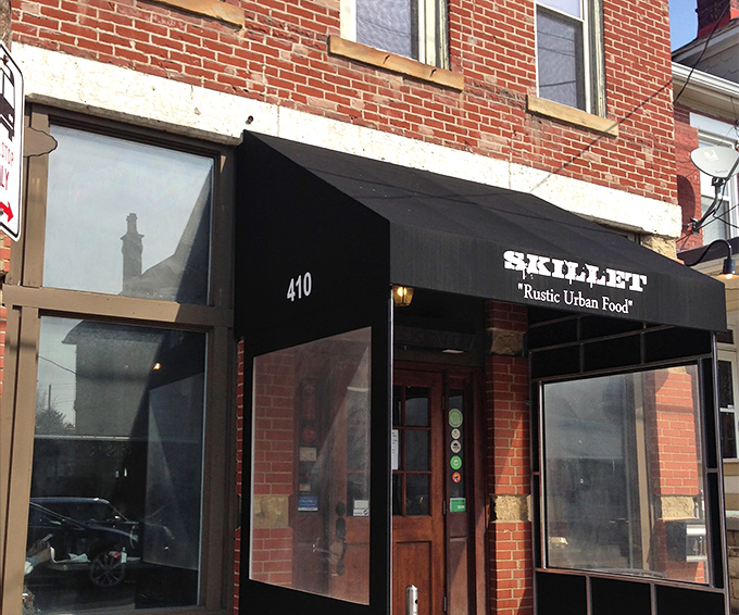 Skillet's unassuming brick exterior in Columbus hides culinary treasures within. The black awning whispers promises that the food inside shouts from the rooftops.