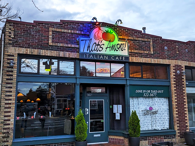 That neon tomato sign isn't just winking at you—it's inviting you into a brick-fronted paradise where pasta dreams come true.
