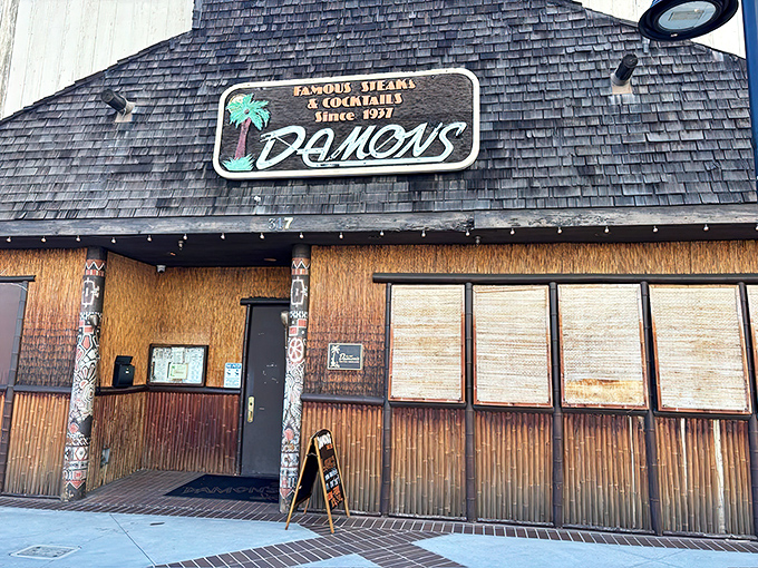 The A-frame entrance to Damon's is like a portal to 1960s Hawaii, complete with banana plants standing guard like tropical bouncers.