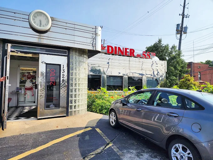 The gleaming stainless steel exterior of Diner on 55th stands like a time machine to the golden age of American dining. That vintage clock isn't just keeping time—it's preserving it.