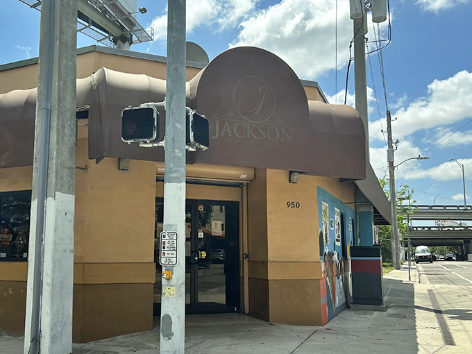 The unassuming peach-colored exterior with its burgundy awning is Miami's soul food beacon – no flash, just pure culinary promise waiting inside.