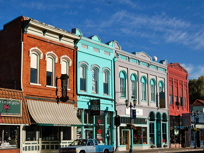 Main Street's candy-colored facades aren't just Instagram bait—they're living history where locals still gather for gossip and surprisingly good pizza.