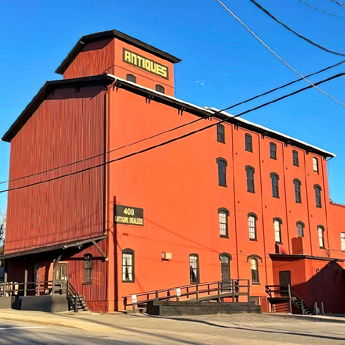 The brilliant vermilion exterior of Roller Mills Marketplace isn't just eye-catching—it's practically screaming "treasure inside!" like a four-story siren call to antique lovers.