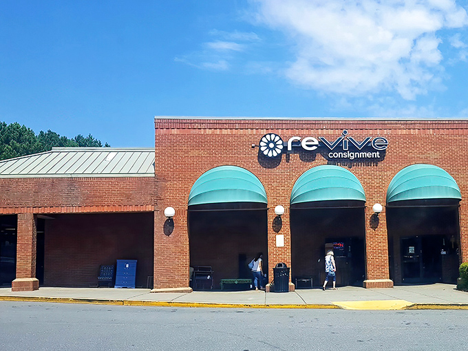Revive's distinctive brick façade with teal awnings stands like a beacon for bargain hunters. It's not just a store—it's a treasure hunt with a roof.
