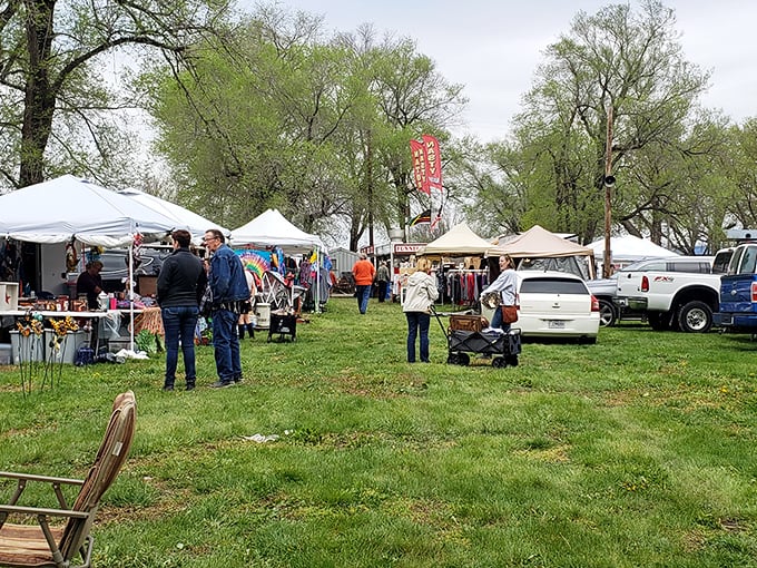 An aerial view reveals Sparks Flea Market's true scale—a sprawling treasure hunter's paradise nestled among Kansas farmland, where parking lots fill with hopeful bargain seekers.